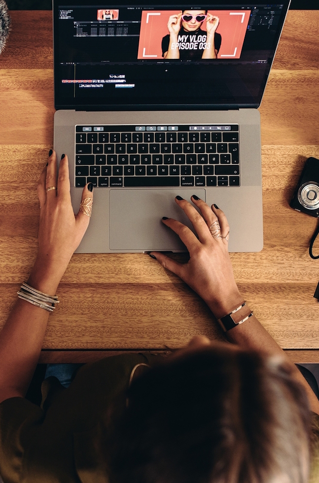 Young Female Vlogger Editing Her Vlog On Computer. - Taylor Kaye